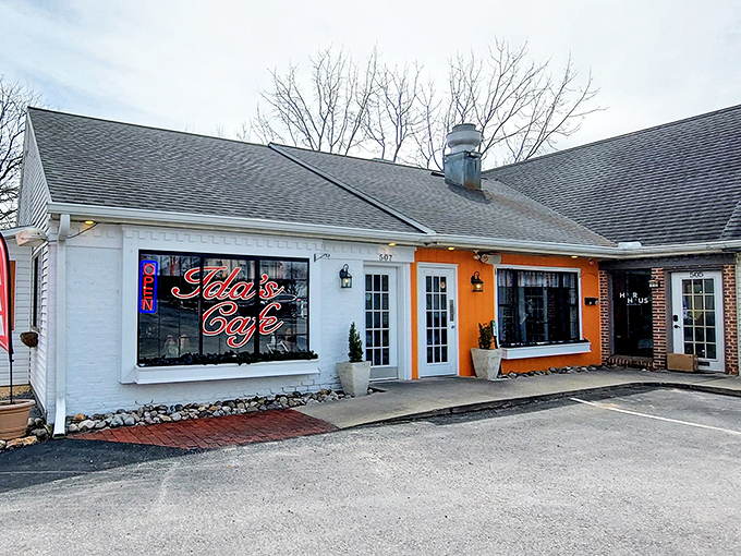 The striking orange accent wall and white trim create that perfect balance of cozy and cheerful – like a breakfast hug waiting to happen.