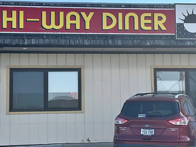 The bold red-and-yellow sign of Hi-Way Diner beckons travelers with the promise of classic roadside comfort food.