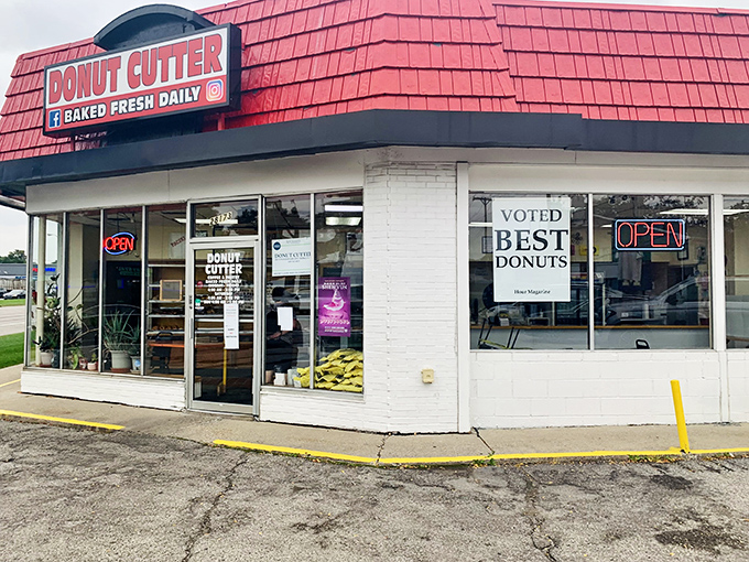 The iconic red-shingled roof of Donut Cutter stands out like a beacon of sugary hope in Berkley. No architectural awards here—just decades of donut perfection.