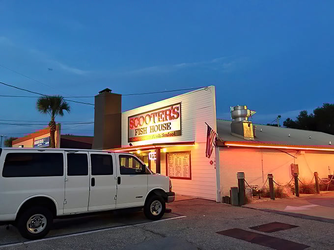 Scooter's glows like a beacon at dusk, its red signage promising seafood salvation to weary travelers along Florida's Panhandle. No pretense, just promise.