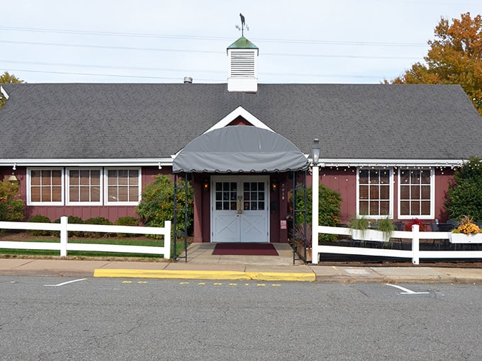 The cozy red barn exterior invites travelers to step inside, where hearty steaks and warm hospitality make “Virginia’s Finest Steakhouse” more than just a claim—it’s the truth.