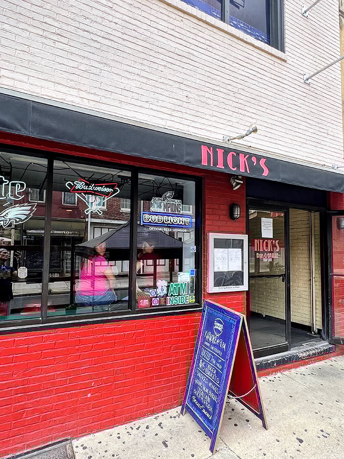 The red brick exterior of Nick's beckons like an old friend, promising comfort food and cold drinks behind that unassuming façade.