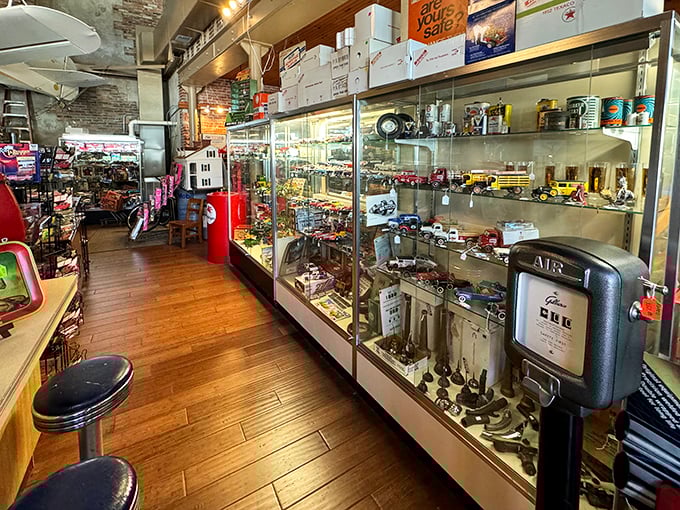 Glass display cases line wooden floors at Toy Town Antiques, where childhood memories wait behind every pristine cabinet door.