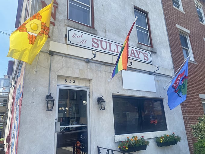 The classic "Eat At Sulimay's" sign beckons hungry travelers like a lighthouse for breakfast enthusiasts. Those colorful flags aren't just decoration—they're surrender flags from defeated appetites.