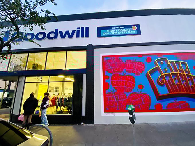 The vibrant exterior of Goodwill on Fillmore Street features a striking red mural, beckoning treasure hunters with its promise of affordable finds.