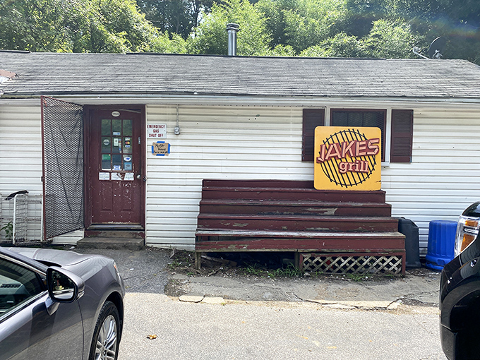 That bright yellow sign against the white clapboard is like a beacon to barbecue pilgrims—simple, straightforward, and promising smoky salvation inside.
