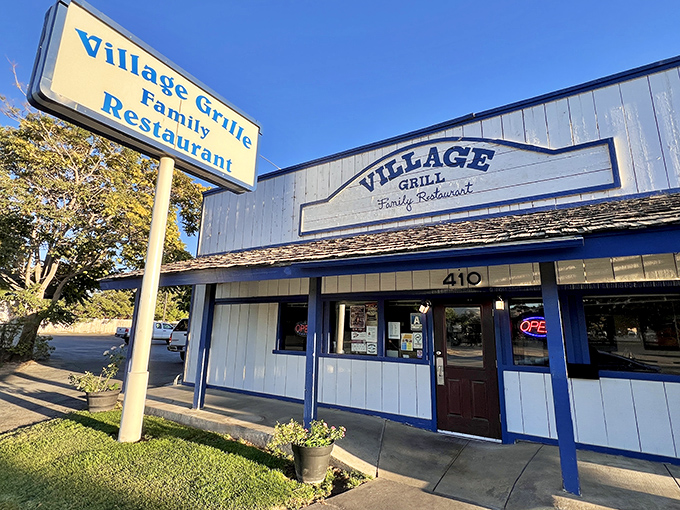 The blue-trimmed exterior of Village Grill stands like a beacon of comfort food promise in Tehachapi, inviting hungry travelers to discover what locals already know.