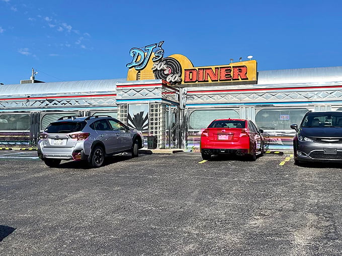 The gleaming chrome exterior of DJ's 50's & 60's Diner shines like a time machine, beckoning hungry travelers with promises of nostalgic delights inside.
