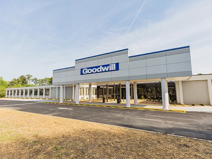 The modern facade of Richmond's Goodwill Outlet stands like a temple to thrift, beckoning bargain hunters with its clean lines and promise of treasures within.
