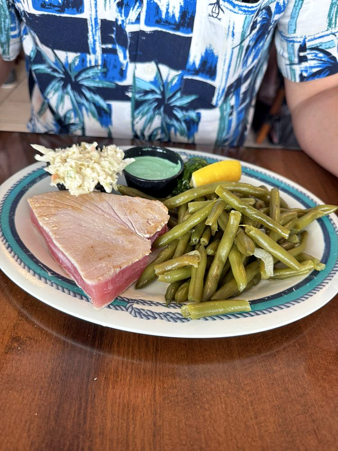 Seared ahi tuna showcasing that perfect pink center – proof that sometimes the best preparation is the one that respects the fish.