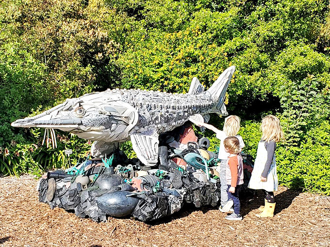 Environmental art at its finest! Children discover that even discarded materials can transform into something magical—like this metallic fish made from repurposed debris.