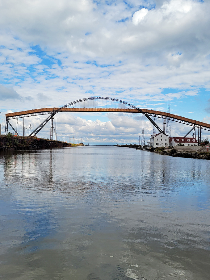 This magnificent bridge arches gracefully over Ashtabula's waterway, proving that functional infrastructure can double as accidental artwork worth admiring.