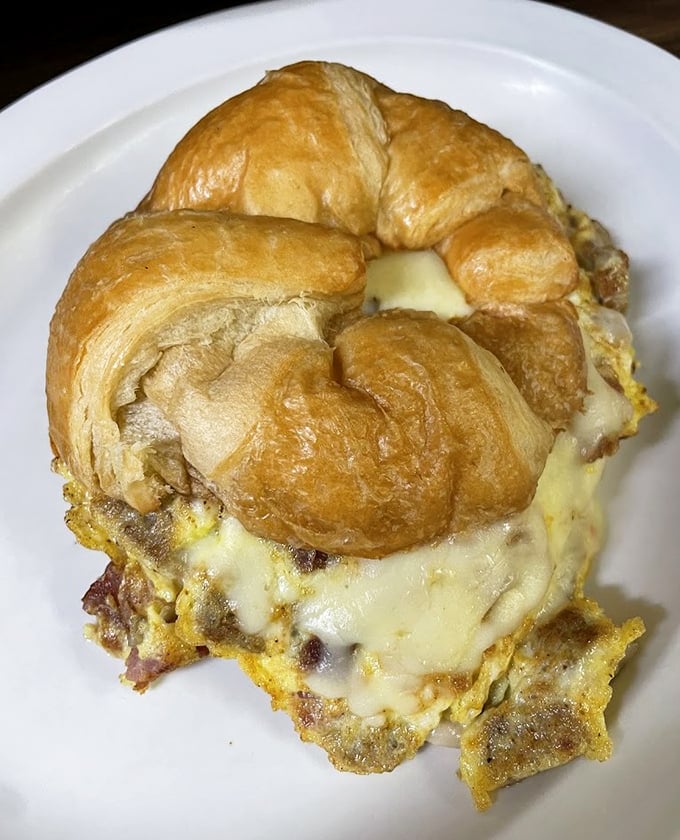 The humble croissant transformed into breakfast royalty—golden, flaky, and stuffed with melty cheese and eggs. Morning commutes were invented for sandwiches like this.