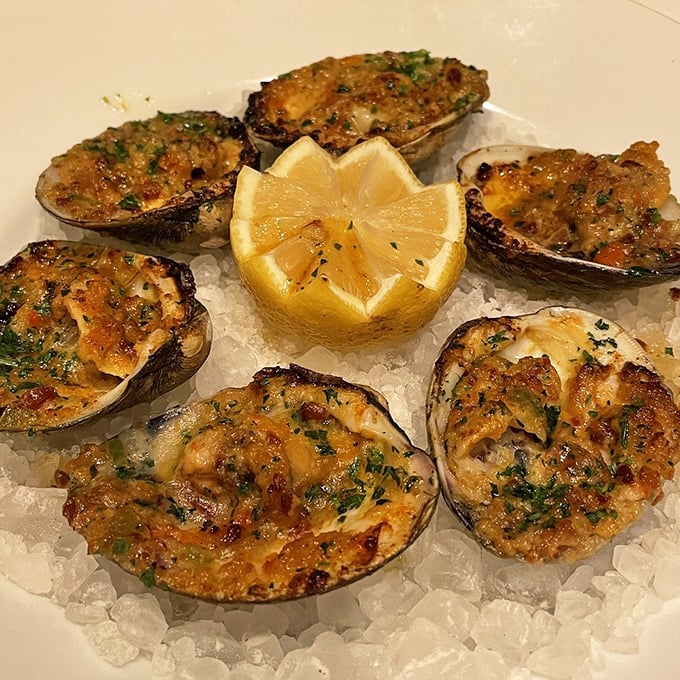 Baked clams that glisten with buttery goodness, arranged around a bright lemon star—seafood simplicity that lets the ocean's flavors shine through.