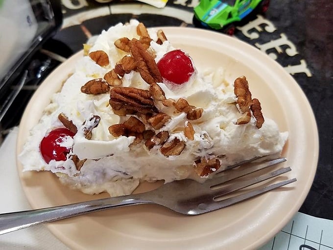 Banana split pie topped with pecans and cherries proves that sometimes dessert needs to be as extra as possible.