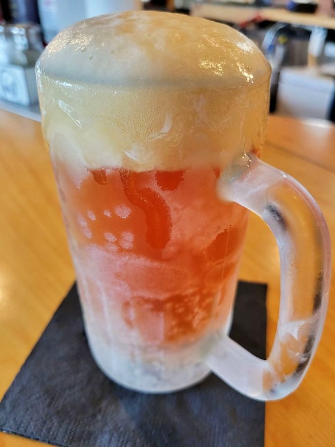 A frosty mug of beer with that perfect foam cap—because sometimes the best barbecue wingman comes in liquid form.