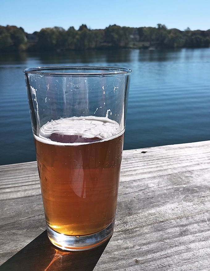 Cold beer with a river view creates the perfect pause between bites of Ohio's most underrated barbecue experience.