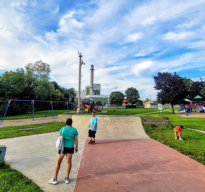Berlin Recreation Park offers simple pleasures—swings, slides, and skateboard ramps—against a backdrop of industrial heritage and blue skies.