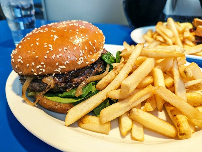 This burger isn't just food—it's architecture. The sesame seed bun like a dome atop a temple dedicated to the art of comfort food.