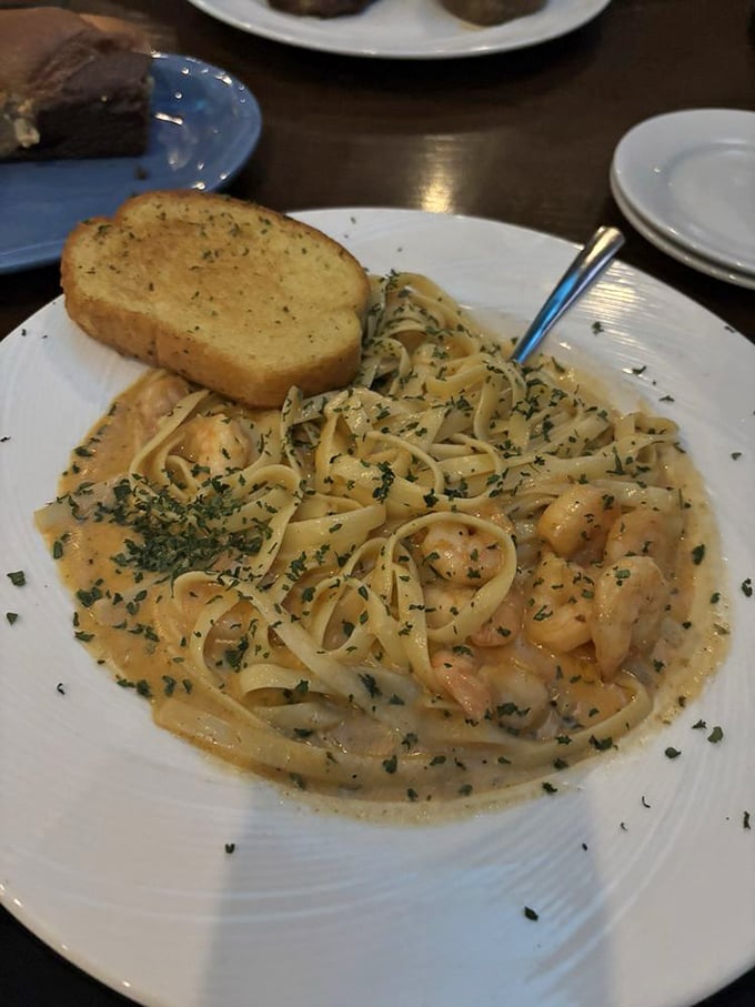 Blackened shrimp swimming in creamy Alfredo sauce with garlic bread—Italian comfort meets Southern spice in perfect harmony.