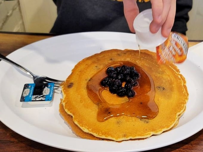 Blueberry pancakes getting the maple syrup treatment they deserve. Those berries aren't just toppings—they're little purple flavor bombs.