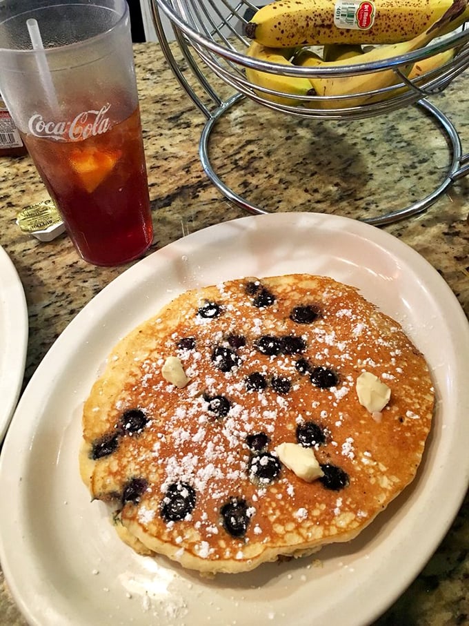 A blueberry pancake that's basically dessert masquerading as breakfast—and nobody's complaining about this delicious deception.