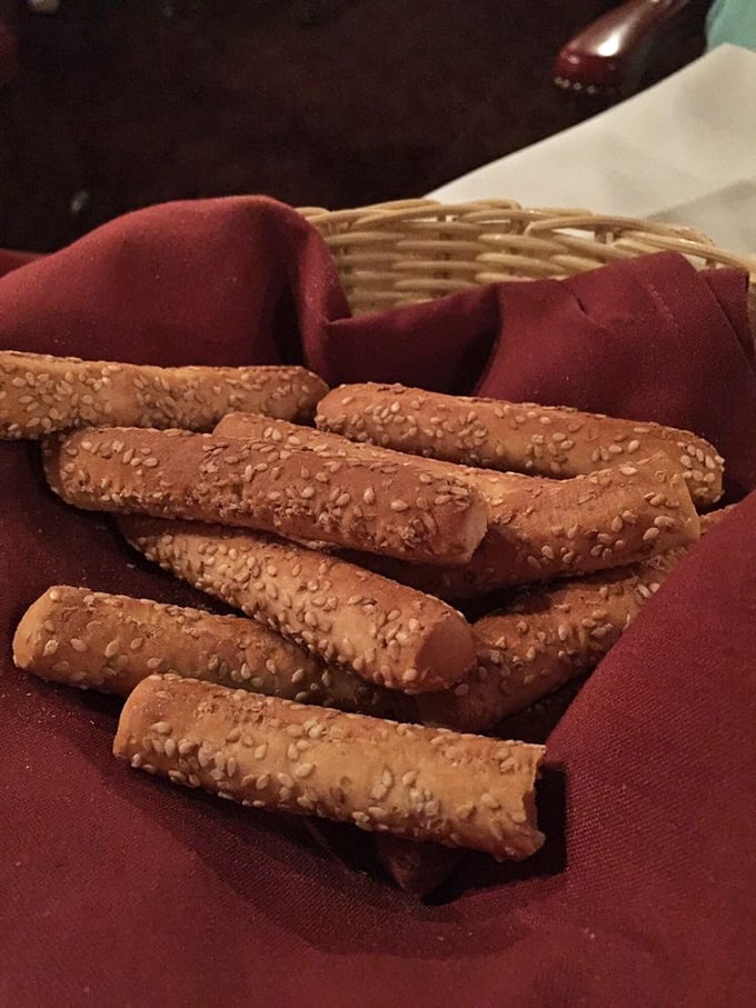 Sesame breadsticks lined up like delicious fence posts—the perfect opening act before the main event, simple yet impossible to stop eating.