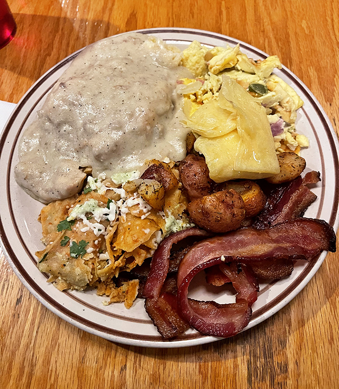 Breakfast done right – eggs, bacon, and potatoes having a delicious morning meeting on your plate.