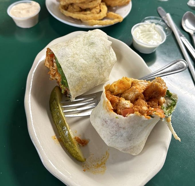 Buffalo chicken wraps with the perfect kick, served with a pickle spear standing guard. The kind of lunch that makes you glad you skipped the salad.