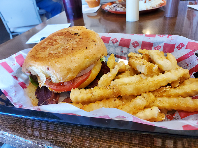 A sandwich that doesn't need to show off—just honest ingredients between perfectly toasted bread, with fries crisp enough to make a potato proud.