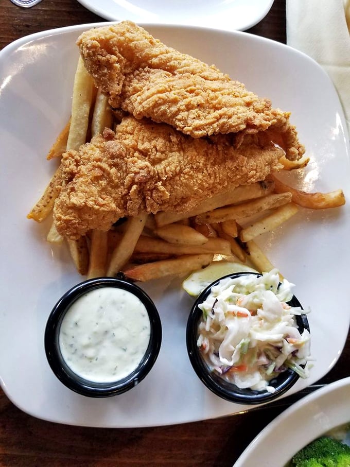 Crispy catfish and fries stacked like a golden Jenga tower – one wrong move and you'll be forced to eat another delicious piece.