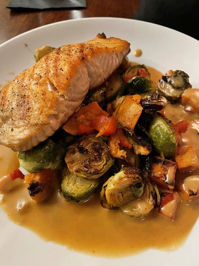 Cedar-planked salmon that's not just cooked – it's been given a spa treatment of roasted vegetables and a buttery sauce bath.
