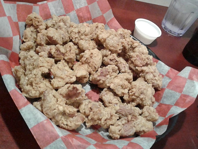 Chicken gizzards – that Midwestern delicacy that divides families and creates lifelong loyalties – fried to crispy, tender perfection on classic checkered paper.