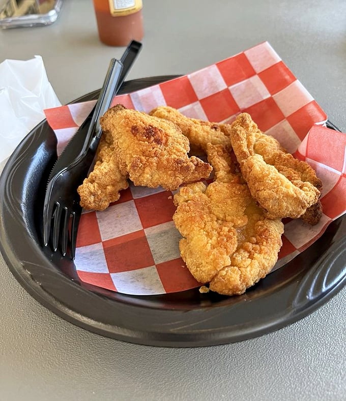 Even the chicken tenders here mean business – golden-fried to perfection on checkered paper, proving that seafood joints know their way around the fryer too.
