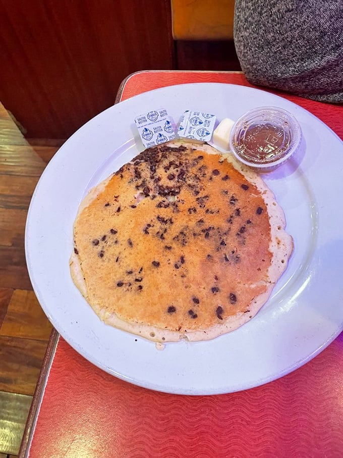 A chocolate chip pancake the size of a frisbee. The maple syrup on the side isn't a condiment—it's a commitment.