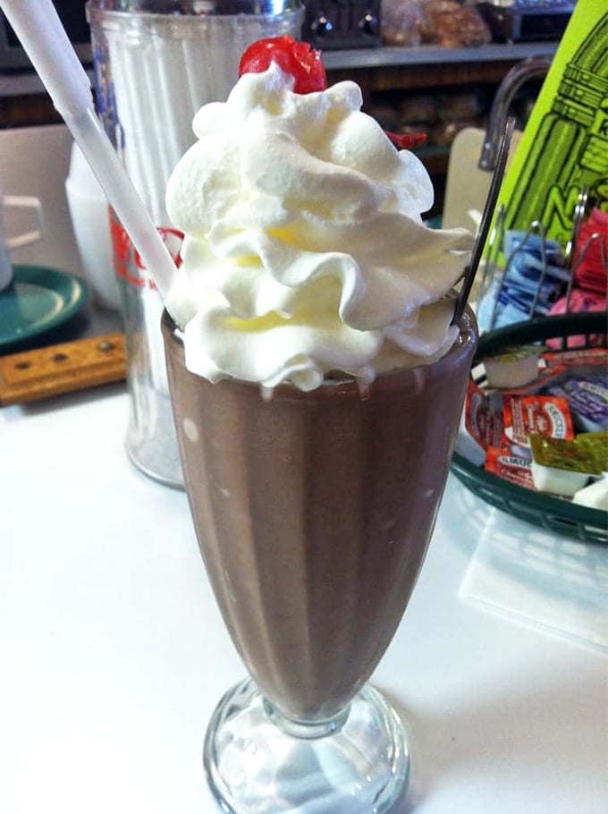 That chocolate milkshake stands tall like a delicious monument to everything right about American diner culture.