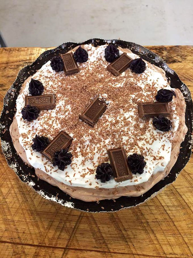This chocolate cream pie with its Hershey's bar garnish isn't trying to impress food critics – it's busy making memories for everyone lucky enough to grab a slice.