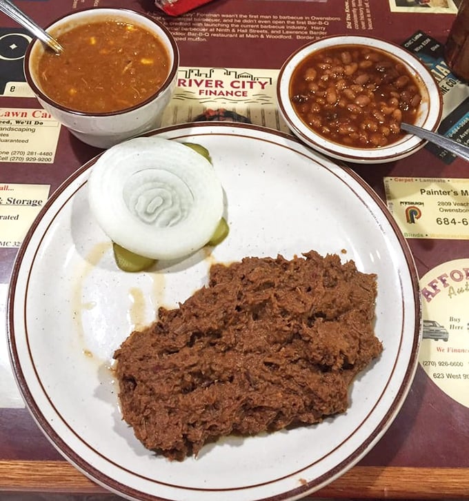 Chopped mutton with burgoo and beans – the holy trinity of Owensboro barbecue. One bite explains why people drive for hours to get here.