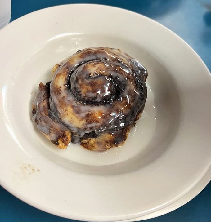 This cinnamon roll isn't playing games – it's the heavyweight champion of breakfast desserts, glazed with enough sweetness to fuel a morning at the track.