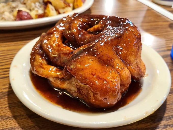 Bubba's Cinnamon Roll doesn't just arrive at your table—it makes an entrance. Glistening with sweet glaze and swimming in cinnamon-scented syrup that demands to be sopped up.