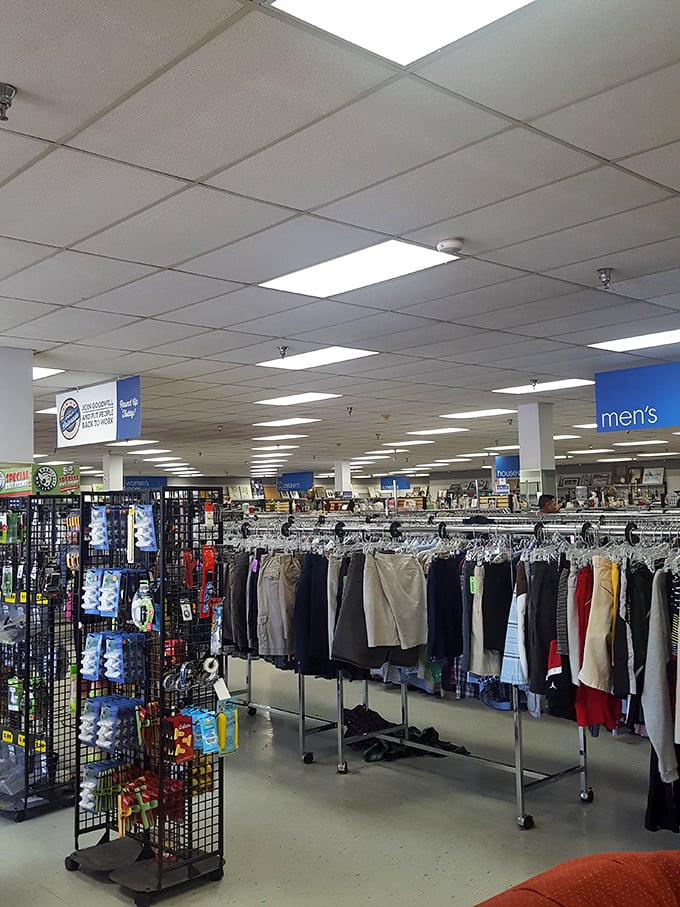Men's department signage hovers above a carefully organized section where Colorado's casual-but-prepared aesthetic finds its perfect expression.