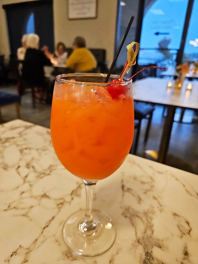 That cocktail's sunset hue promises a brunch that might stretch lazily into afternoon – exactly as the weekend gods intended.