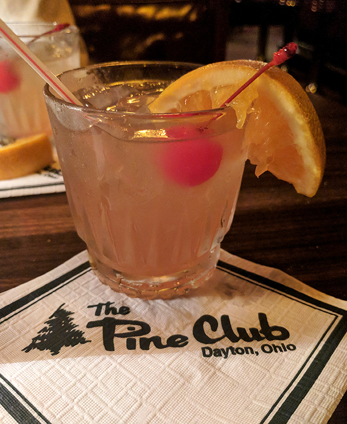 A properly made cocktail with that signature napkin – because at The Pine Club, even the drinks dress for dinner.