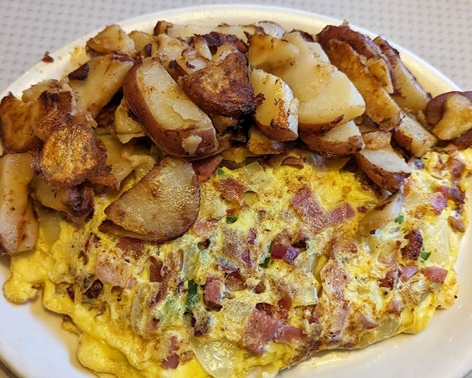 An omelet that's seen things—namely bacon, cheese, and potatoes that sacrificed themselves for the greater good of your breakfast satisfaction.