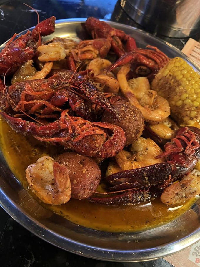 Crawfish, potatoes, and corn swimming in liquid gold—like a Cajun treasure chest that requires no map, just a healthy appetite.