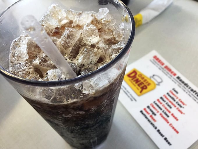 That soda isn't just a beverage—it's a frosty glass time machine to childhood summers when the biggest decision was which flavor to choose.