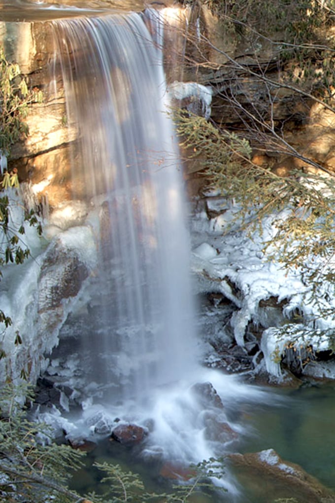 Cucumber Falls drops like a liquid curtain against winter-kissed rocks, proving that frozen landscapes can still have spectacular movement.