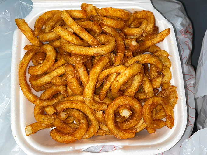 These curly fries spiral into crispy perfection, each one a golden testament to the deep fryer's magic.