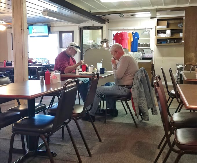Two regulars sharing coffee and conversation – the real magic of diners happens between people, not just on plates.