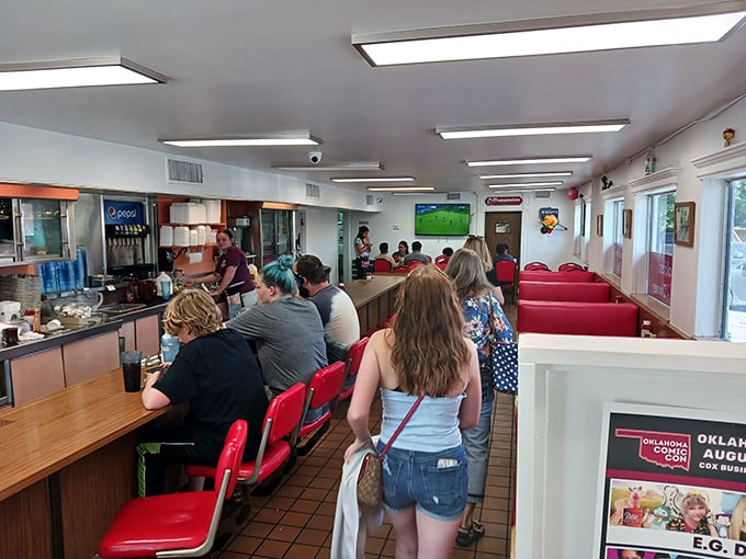 The lunch counter ballet—hungry patrons and efficient staff performing the timeless dance of American diner culture that never goes out of style.